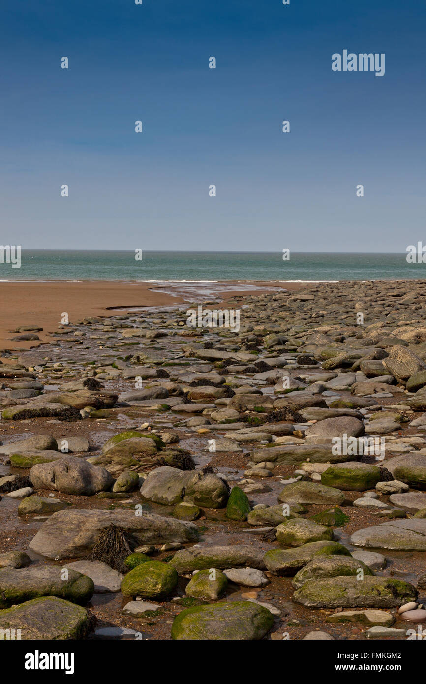 A stream from Exmoor crosses the beach at Lee Bay and empties into the ...