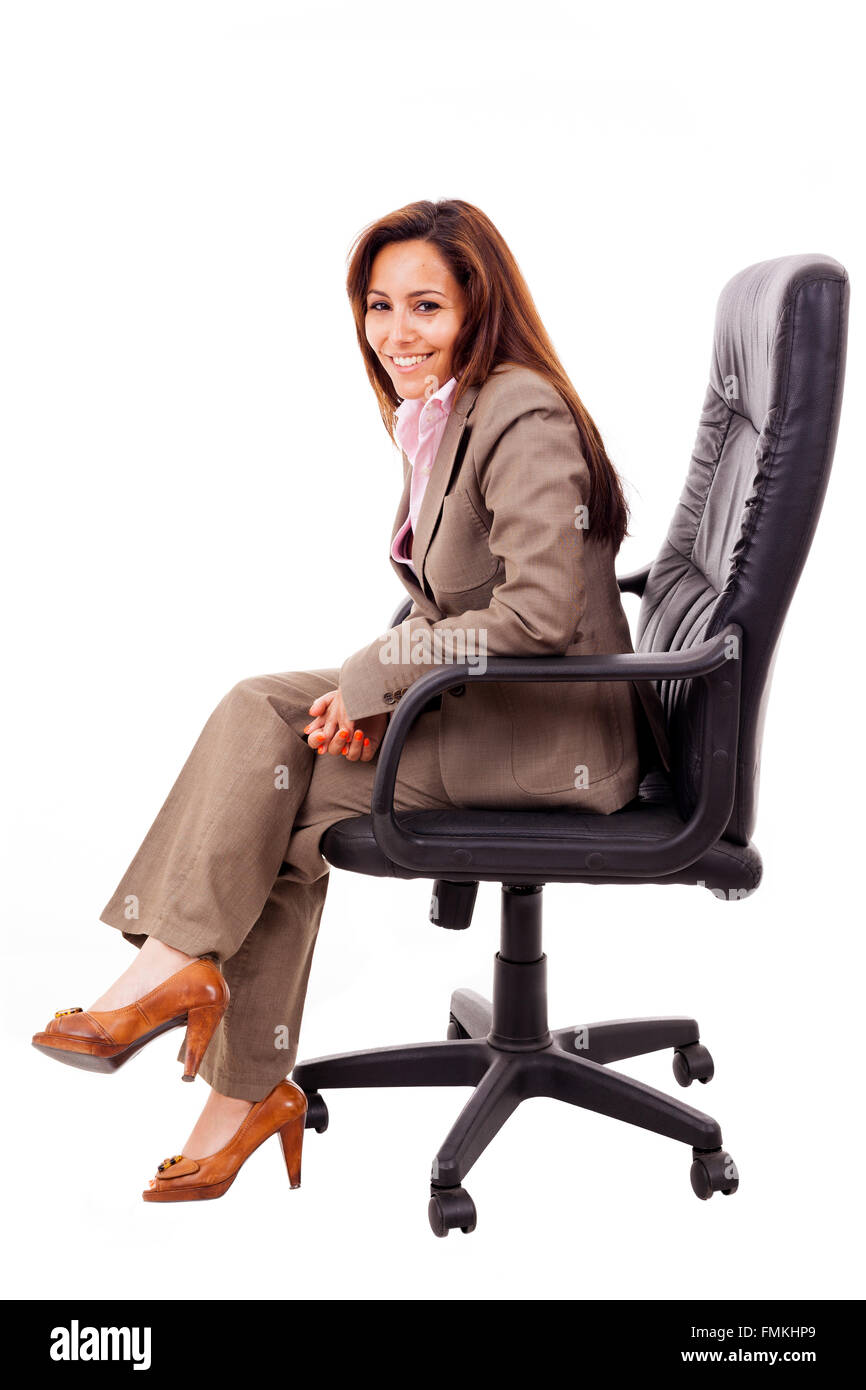 Portrait of beautiful young woman sitting on chair isolated over white ...