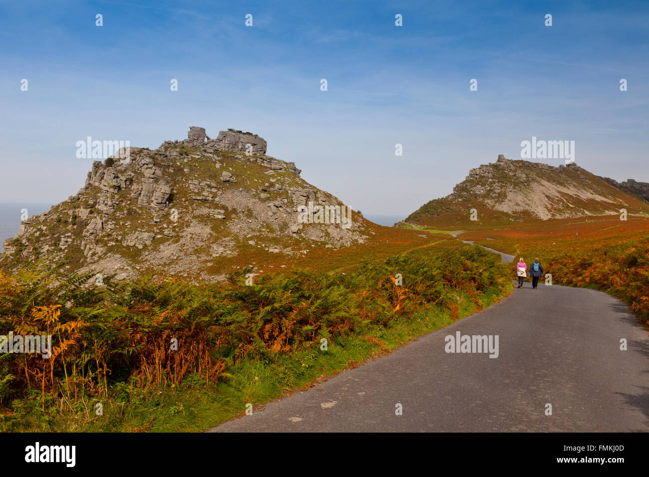 Walkers on the SW Coast Path where the bracken has turned an autumnal ...