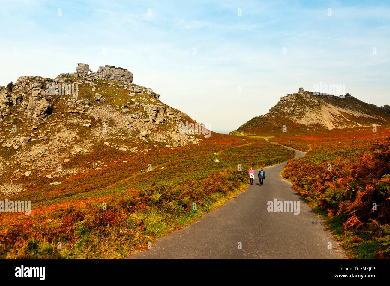 Walkers on the SW Coast Path where the bracken has turned an autumnal ...