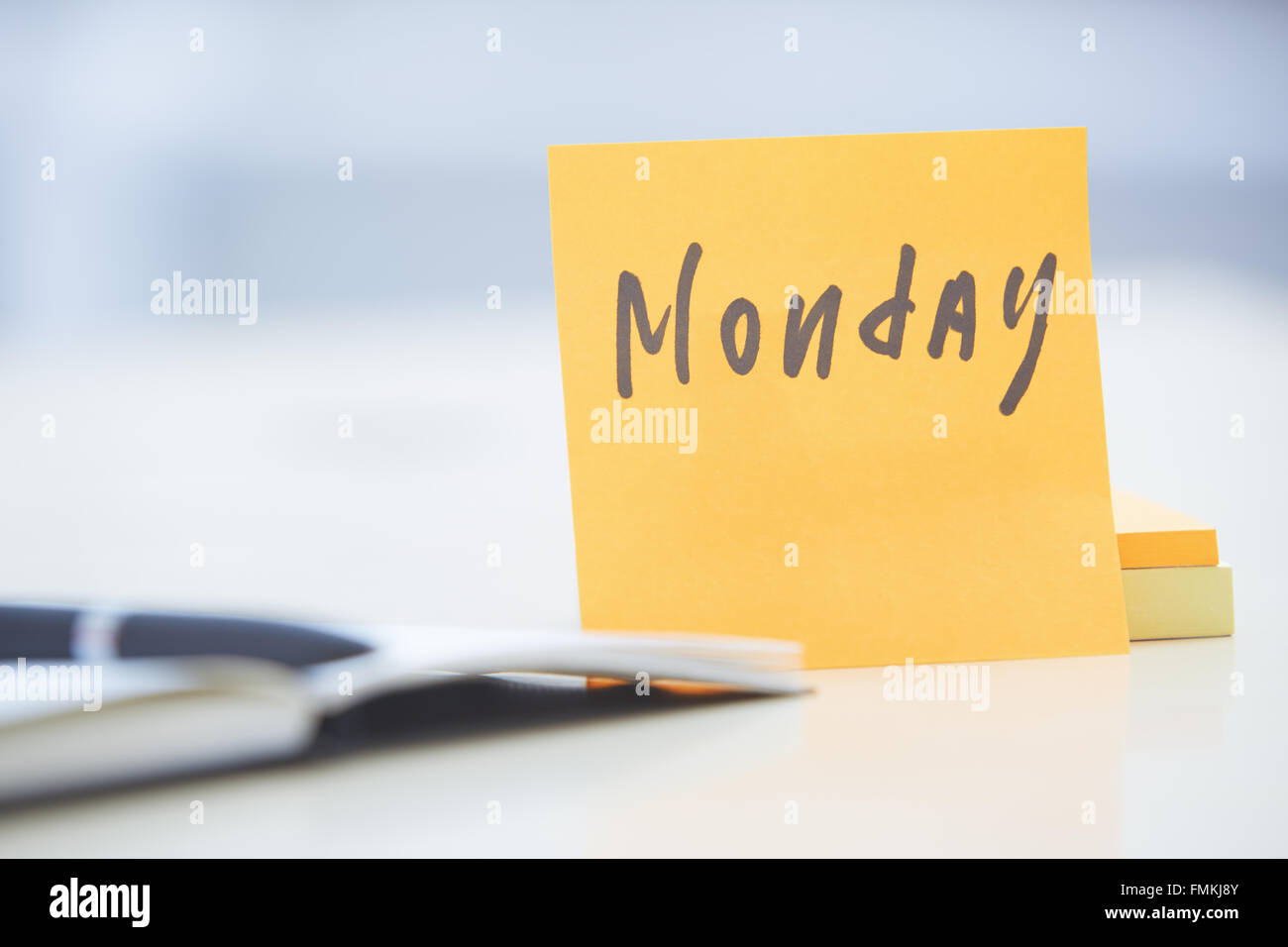 Monday text on adhesive note at office Stock Photo - Alamy