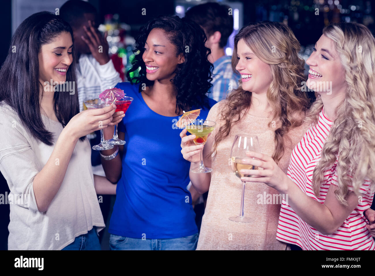 Friends drinking cocktails together Stock Photo - Alamy