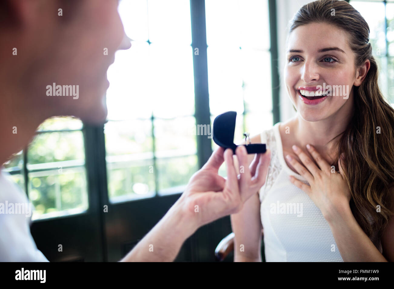Man proposing to woman offering engagement ring Stock Photo - Alamy