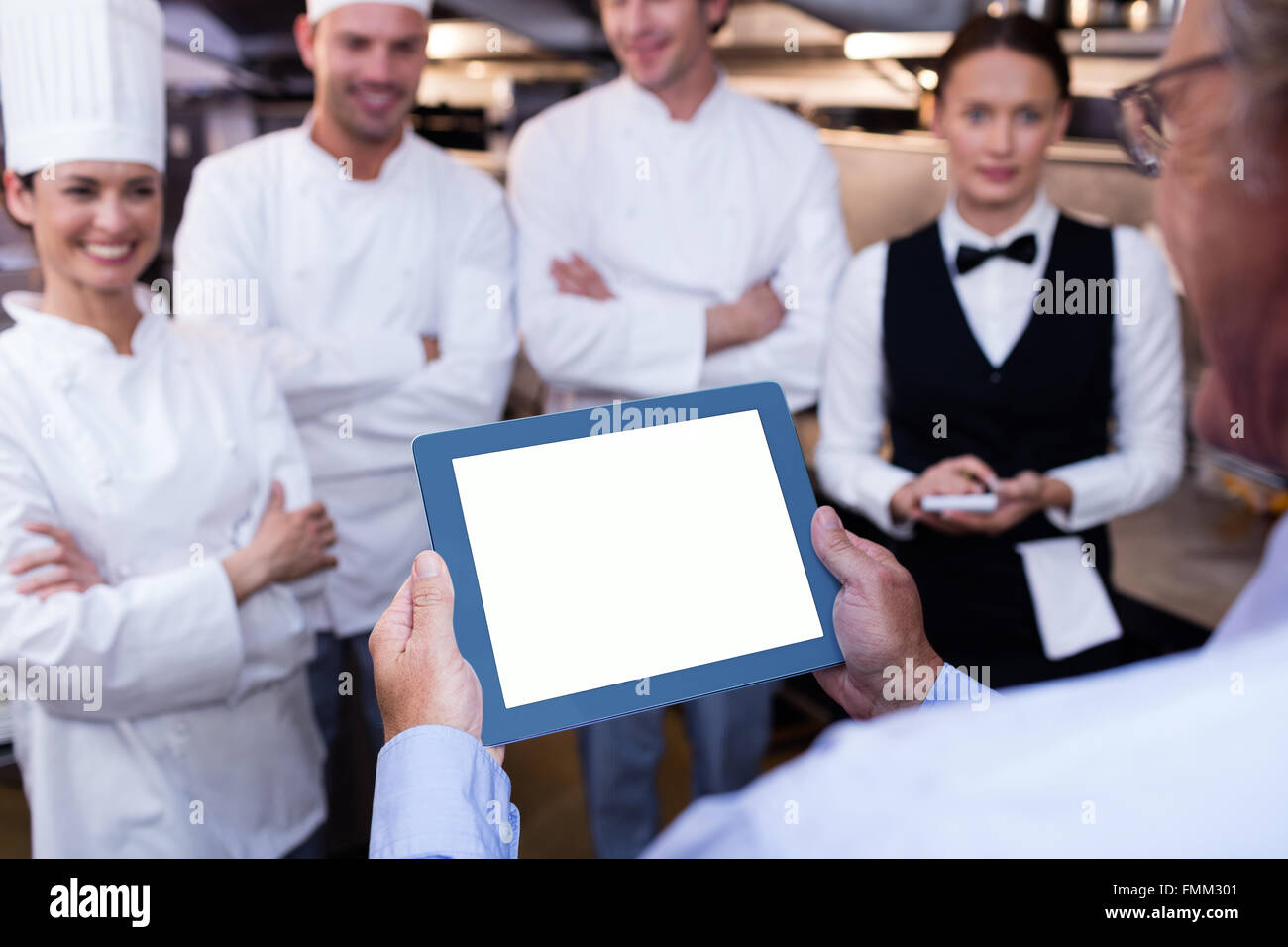 Restaurant manager briefing to his kitchen staff Stock Photo - Alamy