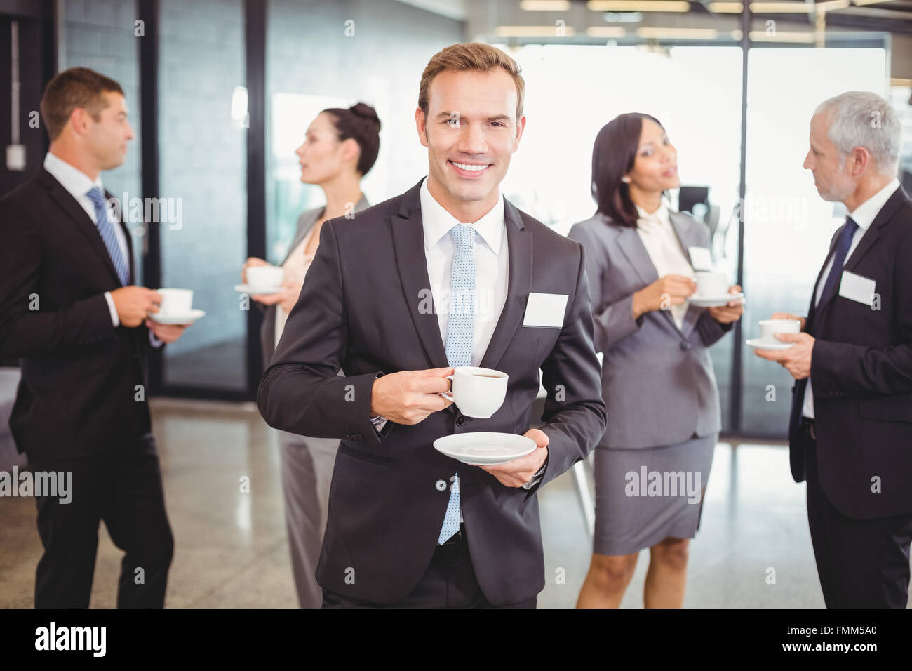 Portrait of businessman having tea during break time Stock Photo - Alamy