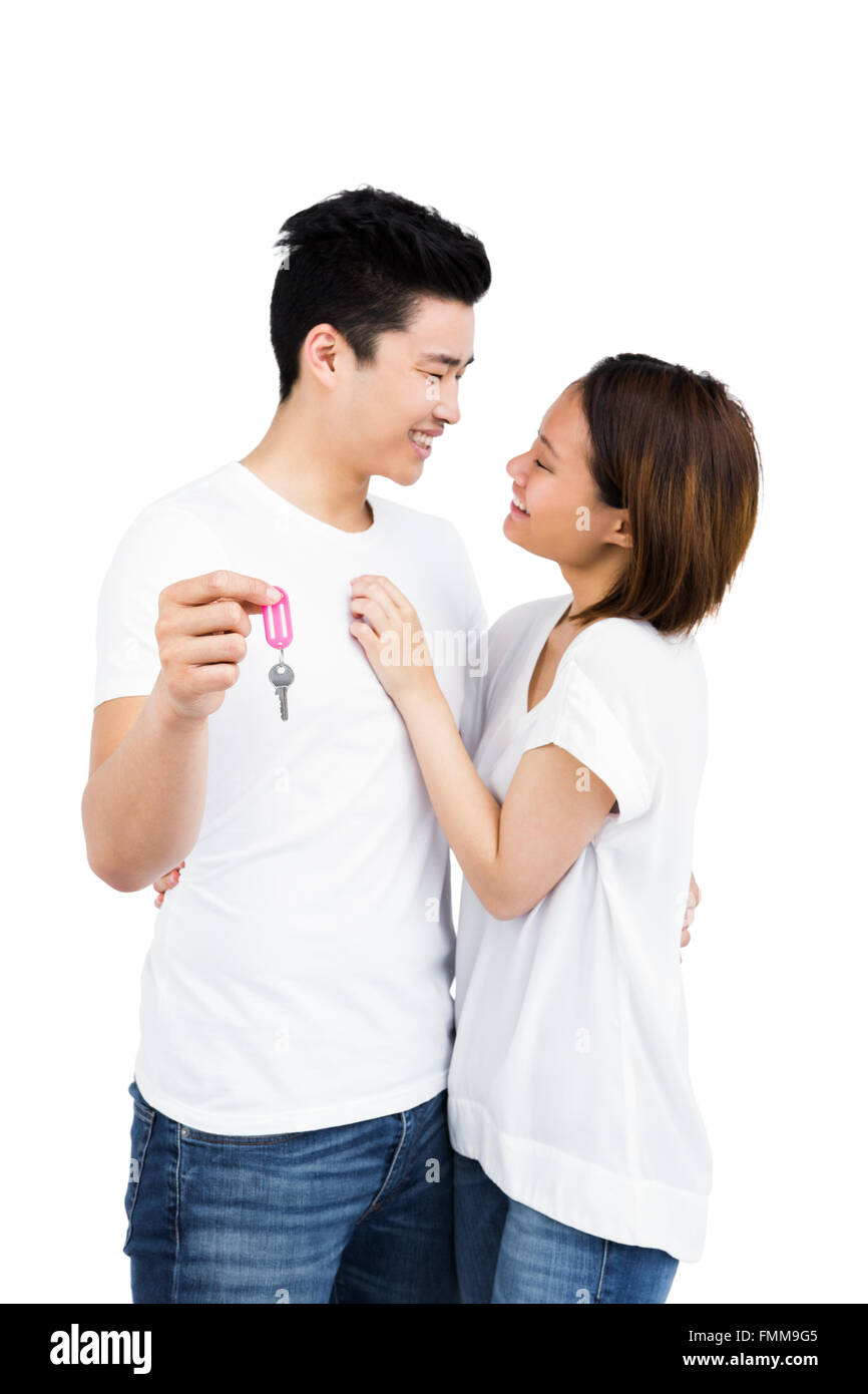 Happy young couple showing key Stock Photo - Alamy