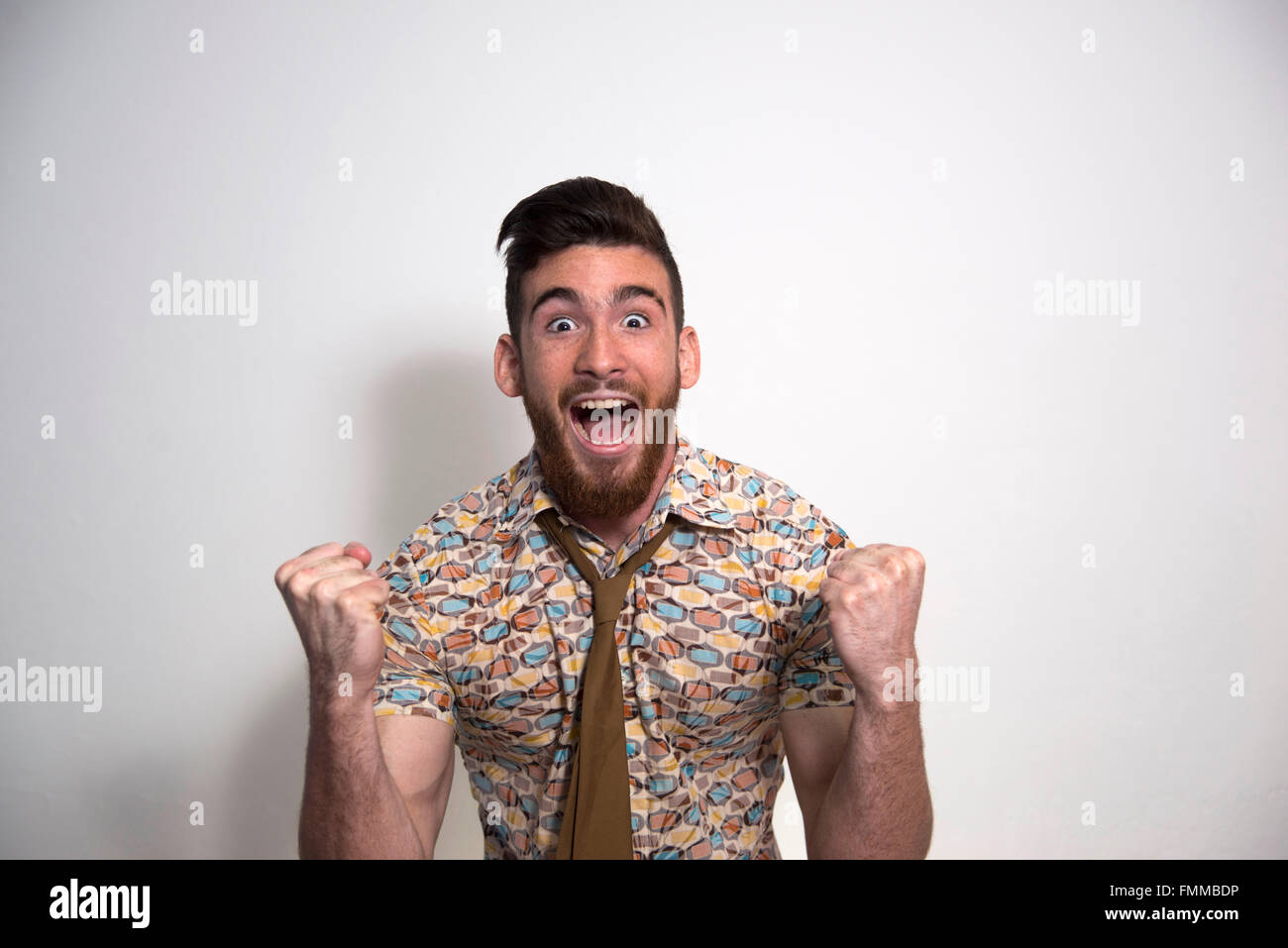 Portrait of young man excited and gesturing Stock Photo - Alamy