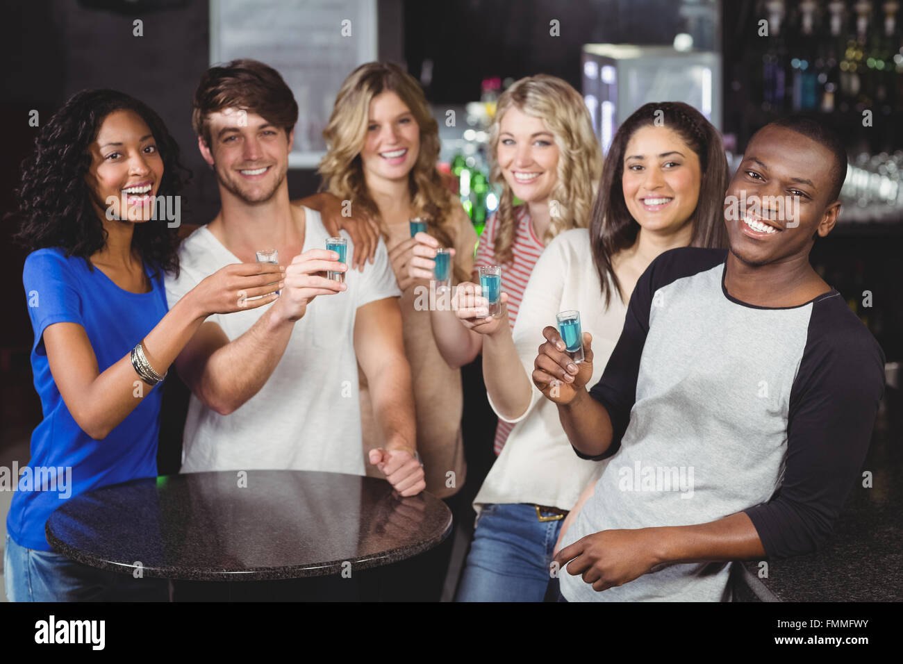 Group of friends having shots Stock Photo - Alamy