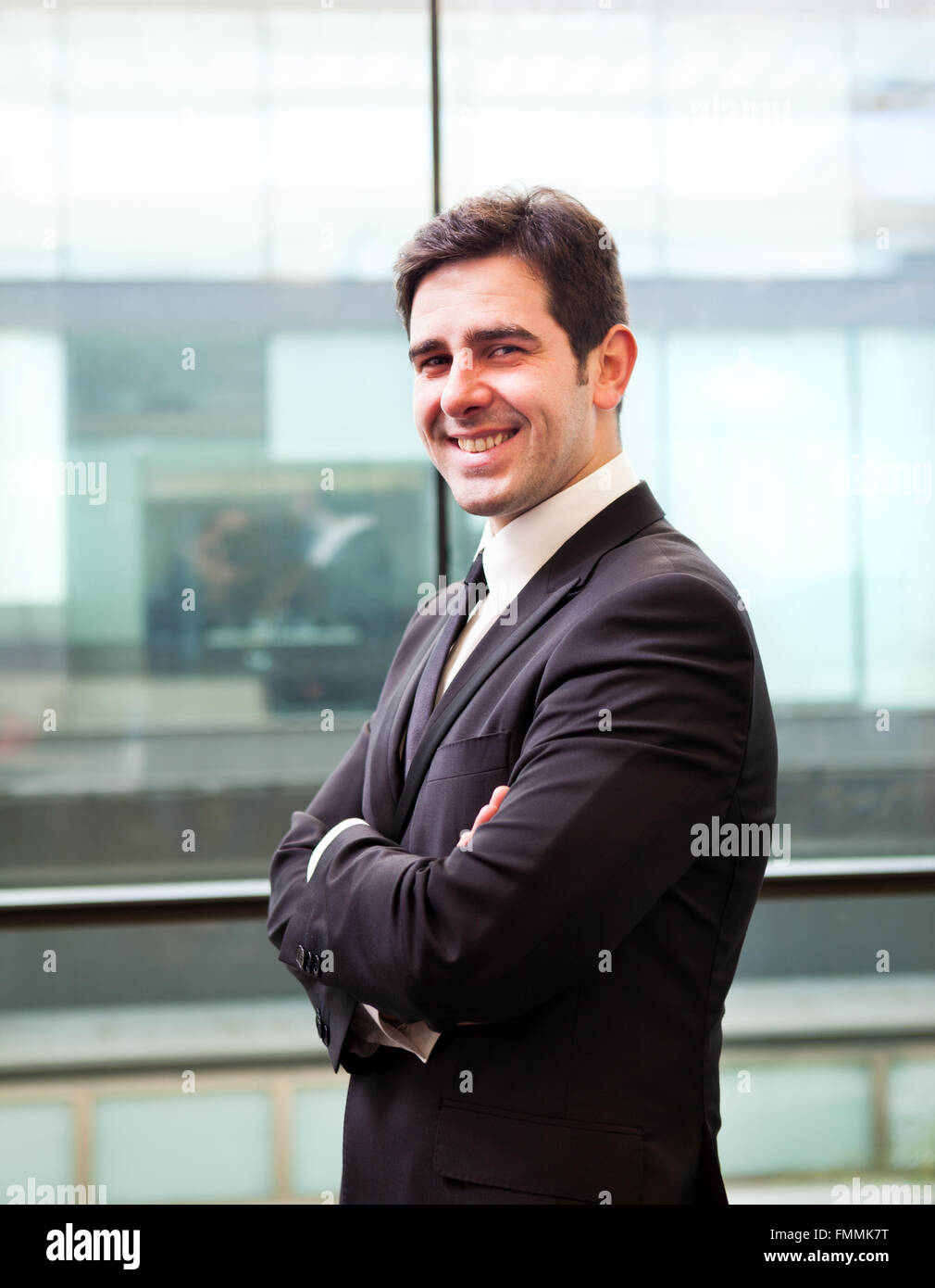Handsome happy business man at the office Stock Photo - Alamy