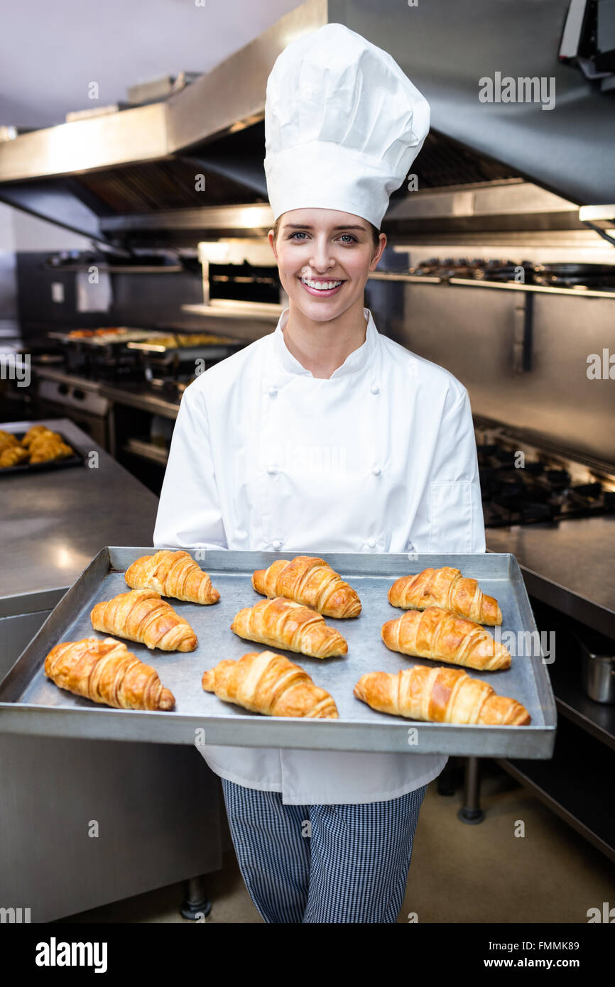 Portrait of a chef holding tray of croissants Stock Photo - Alamy