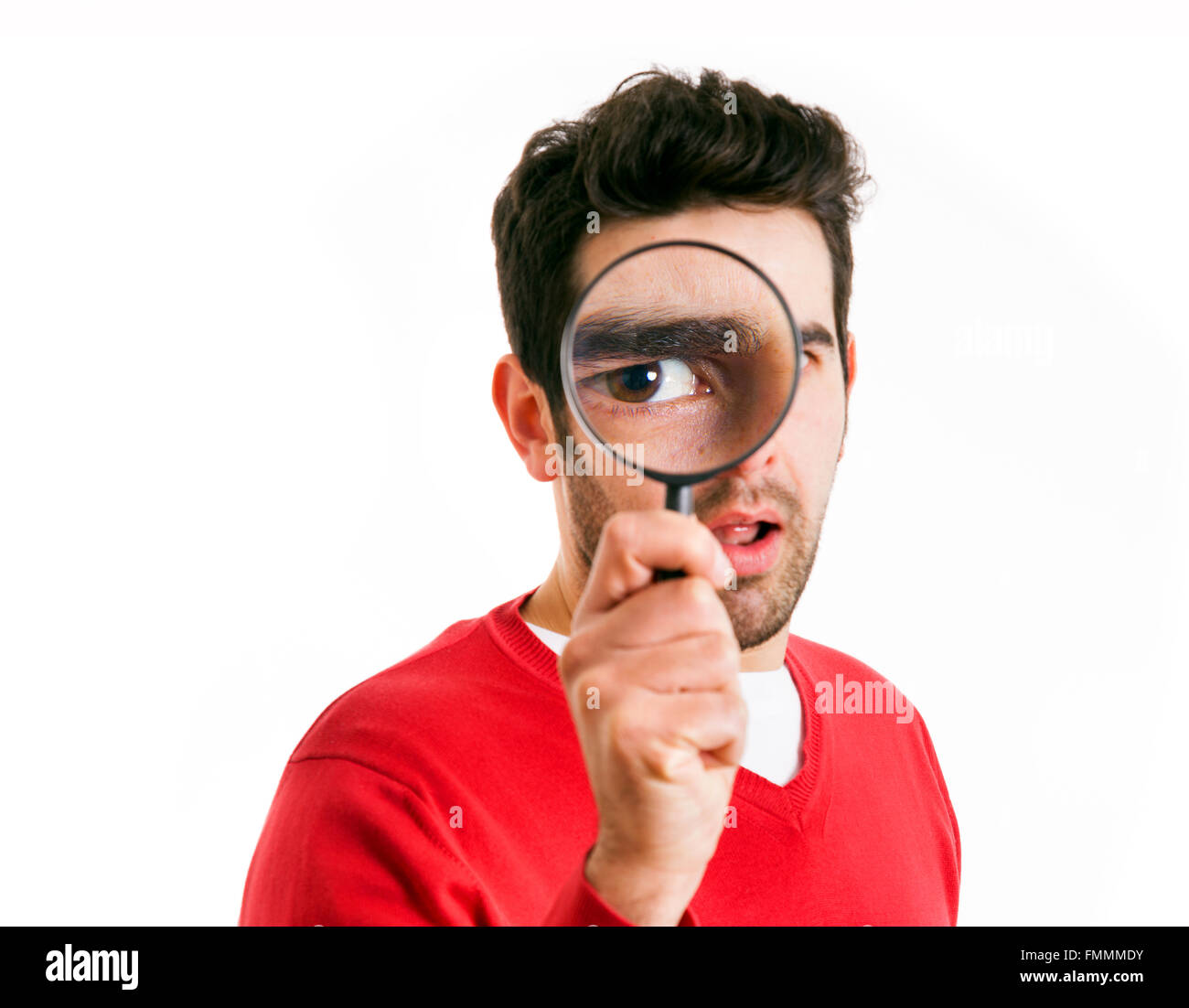 Young man looking through magnifying glass, isolated on white Stock ...