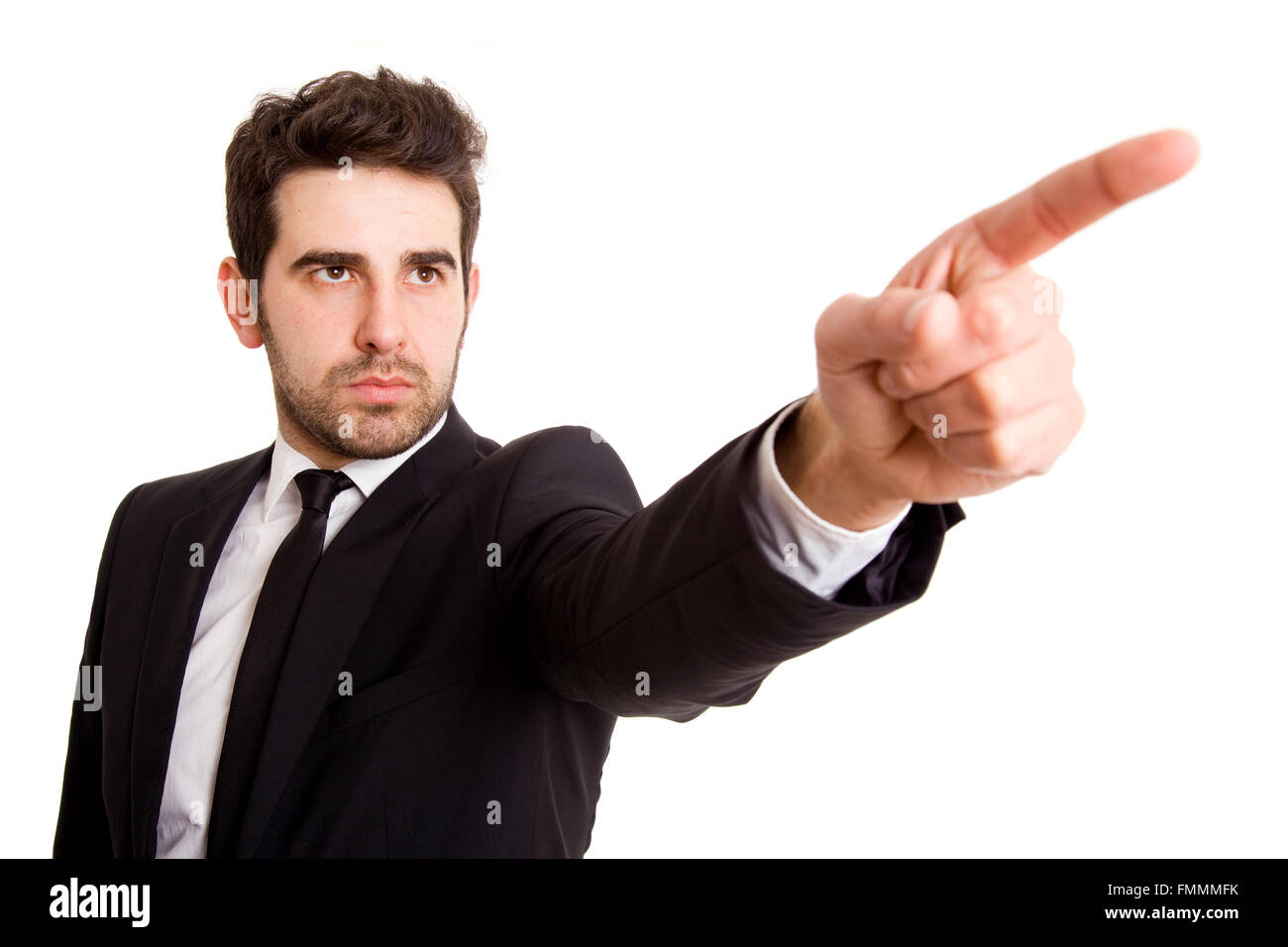 Young business man pointing at something interesting on a white ...