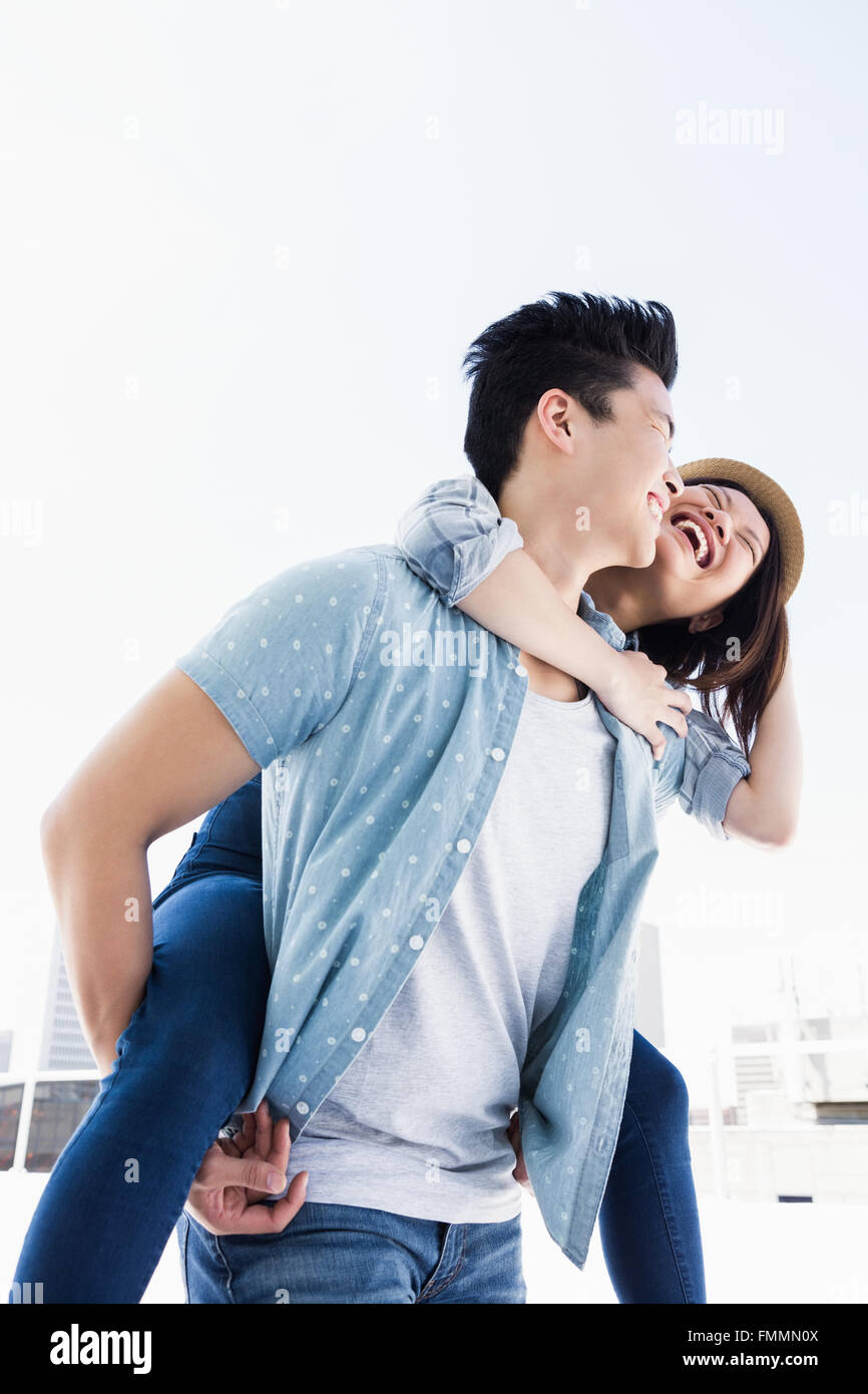 Young man giving a piggyback ride to woman Stock Photo - Alamy