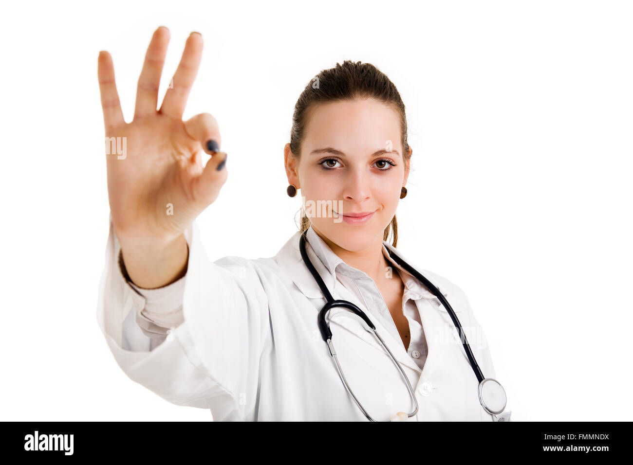 Young doctor signaling OK against white background Stock Photo - Alamy