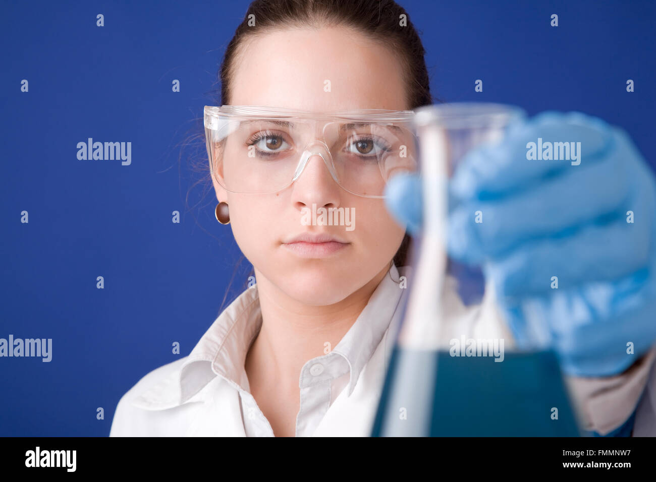 Female researcher against blue background Stock Photo - Alamy