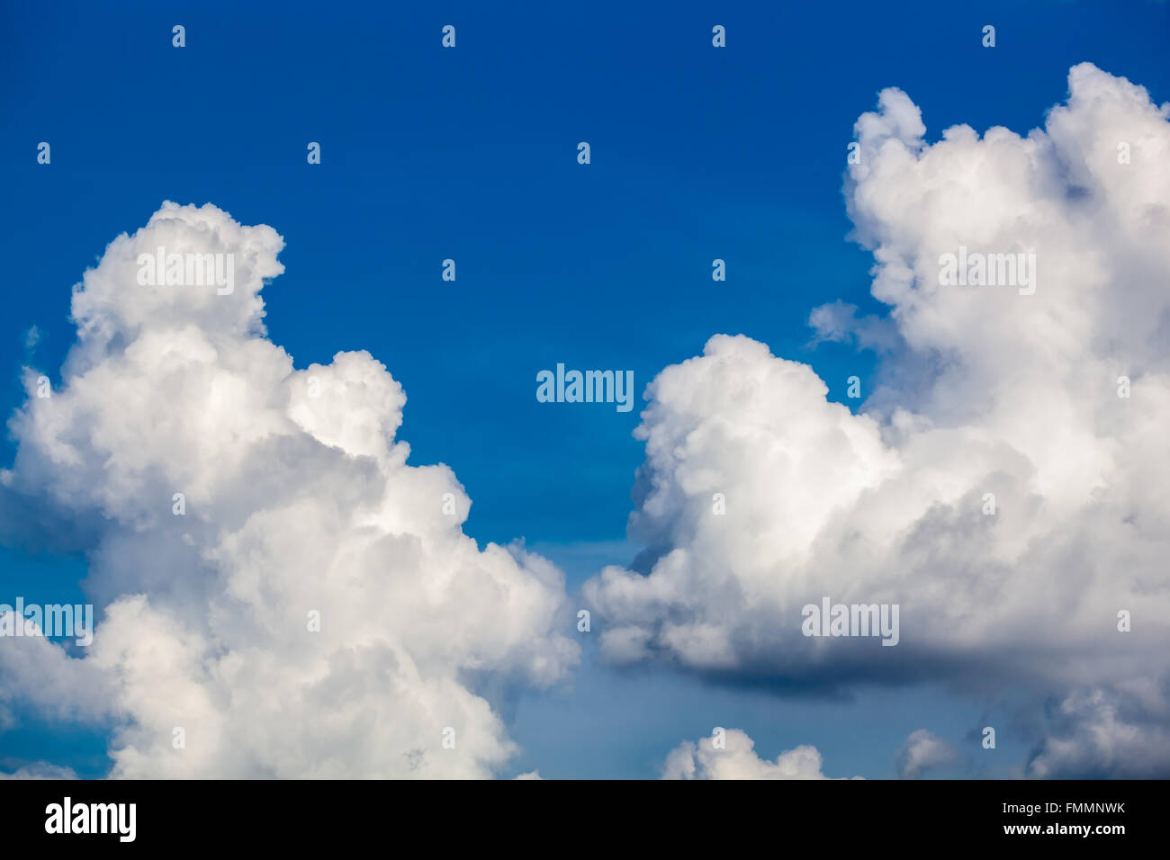 White fluffy clouds pillar in blue sky Stock Photo - Alamy