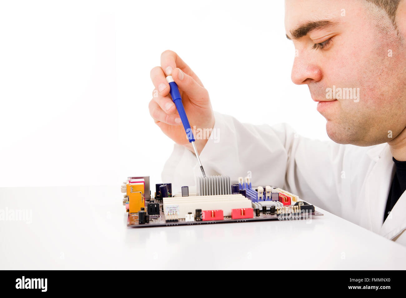 Computer engineer repairing a motherboard, isolated on white Stock ...