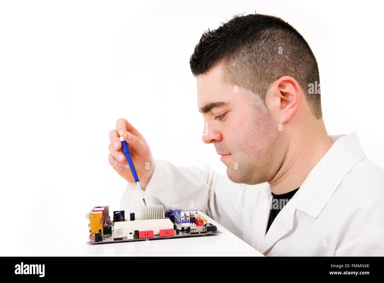 Computer Engineer repairing a motherboard , isolated over white ...