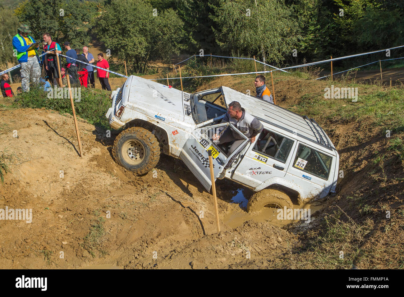 The crew of "drowned" white off road car Stock Photo - Alamy
