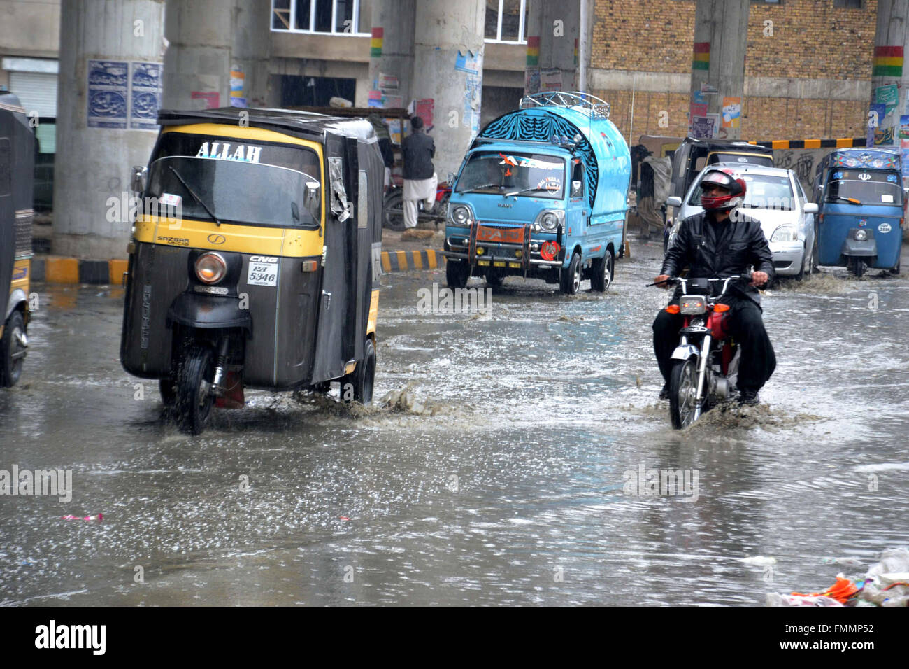 Quetta. 12th Mar, 2016. Vehicles drive through flooded street during ...
