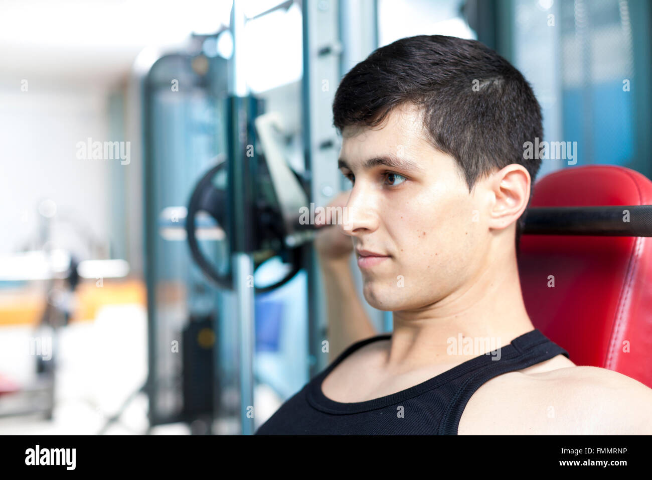 Handsome man lifting heavy weights at the gym Stock Photo - Alamy