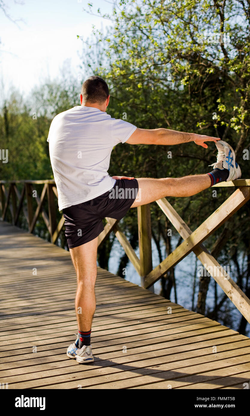 Young man stretching at the park Stock Photo - Alamy