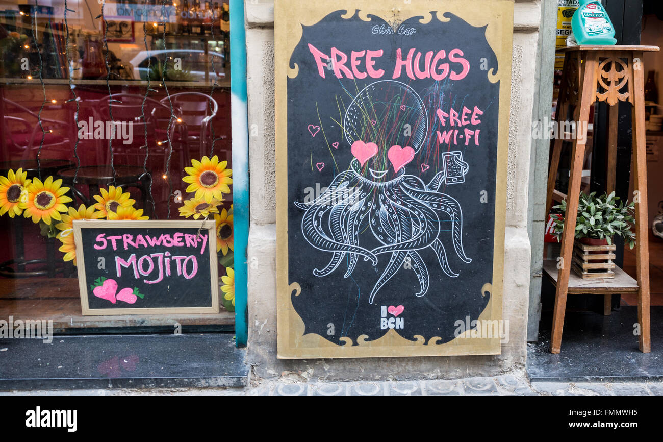 Free hugs sign in small pub in Barcelona, Spain Stock Photo - Alamy