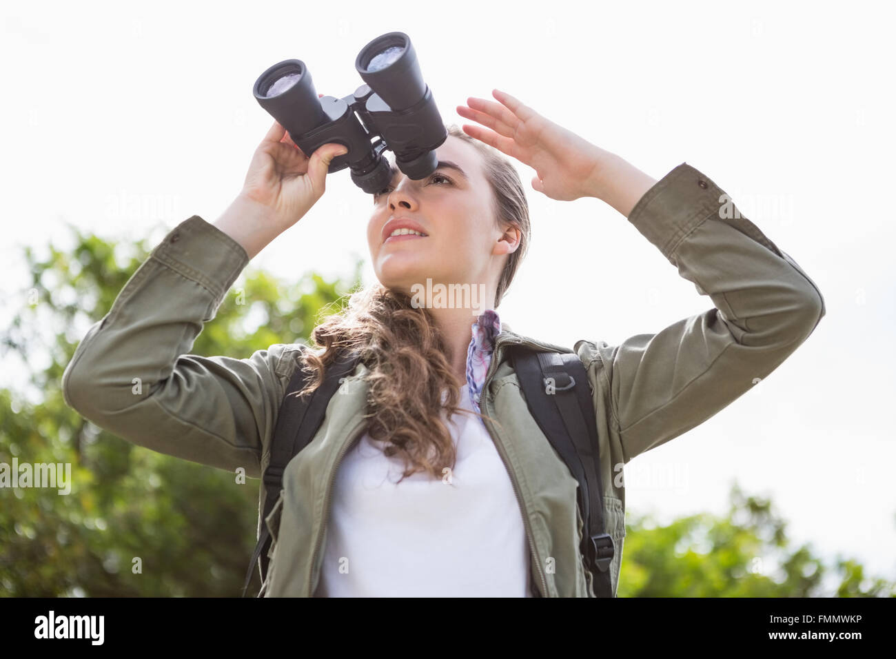 Woman using binoculars Stock Photo - Alamy