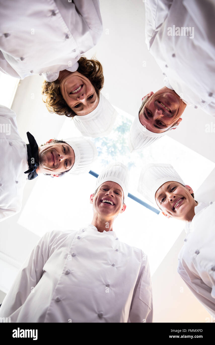Portrait of chefs team standing in a circle wearing uniforms Stock ...