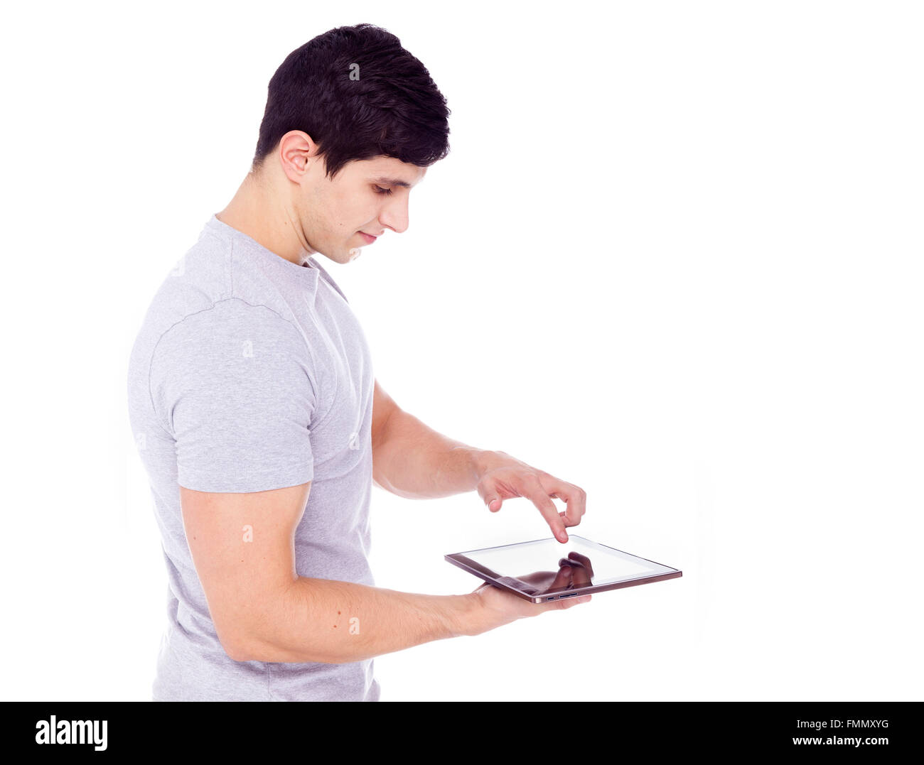 Handsome latin man using a tablet computer, isolated over a white ...