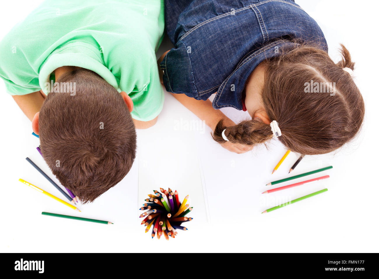 Top view of two children drawing with colorful crayons, isolated over ...
