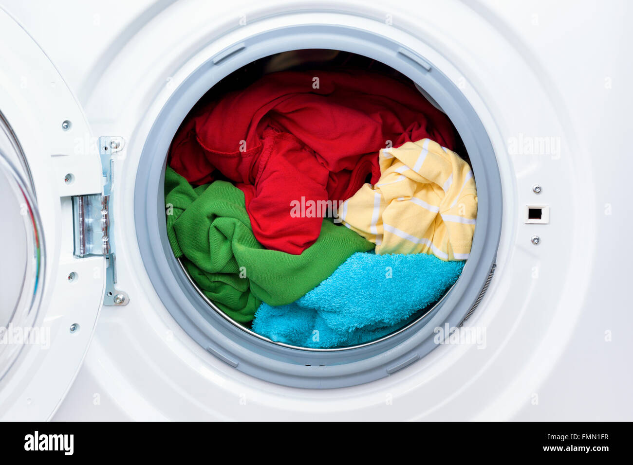 Washing machine with dirty clothes inside, studio shot Stock Photo - Alamy