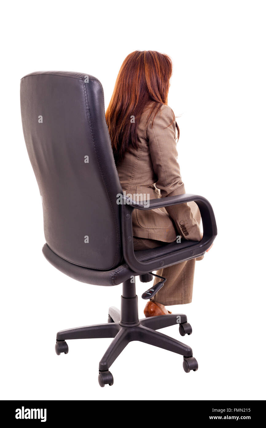 Rear view of young woman sitting on chair isolated over white ...