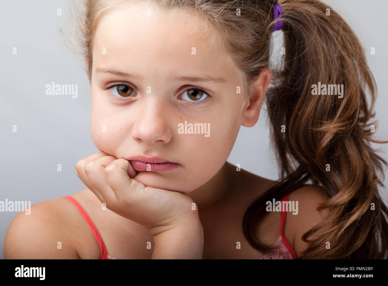 Sad girl on grey background Stock Photo - Alamy