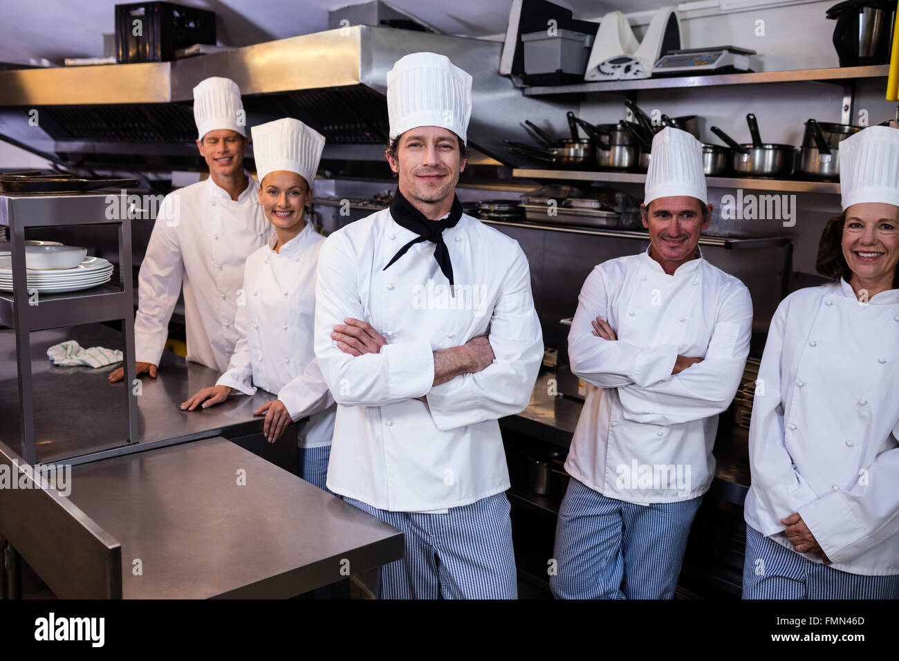 Happy chefs team standing together in commercial kitchen Stock Photo ...