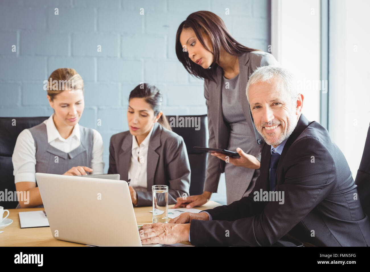 Businesspeople interacting in conference room Stock Photo - Alamy