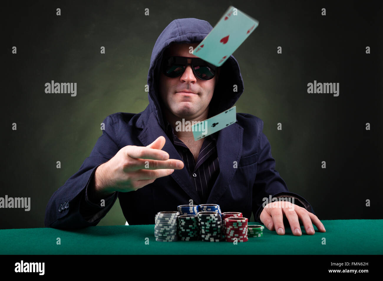 Poker player throwing two ace cards on black background Stock Photo - Alamy