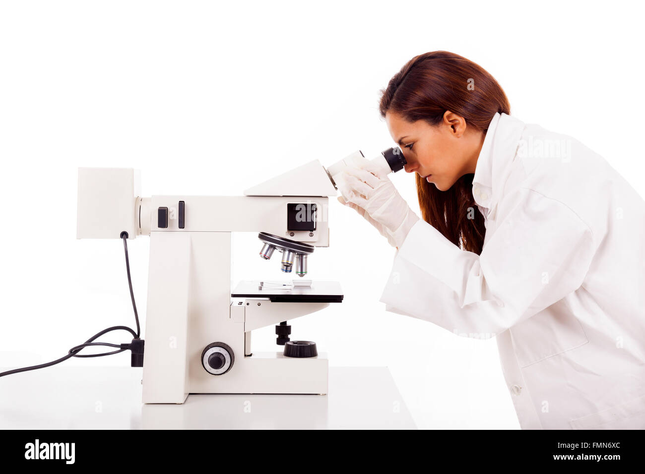 Female researcher looking through microscope, isolated on white Stock ...