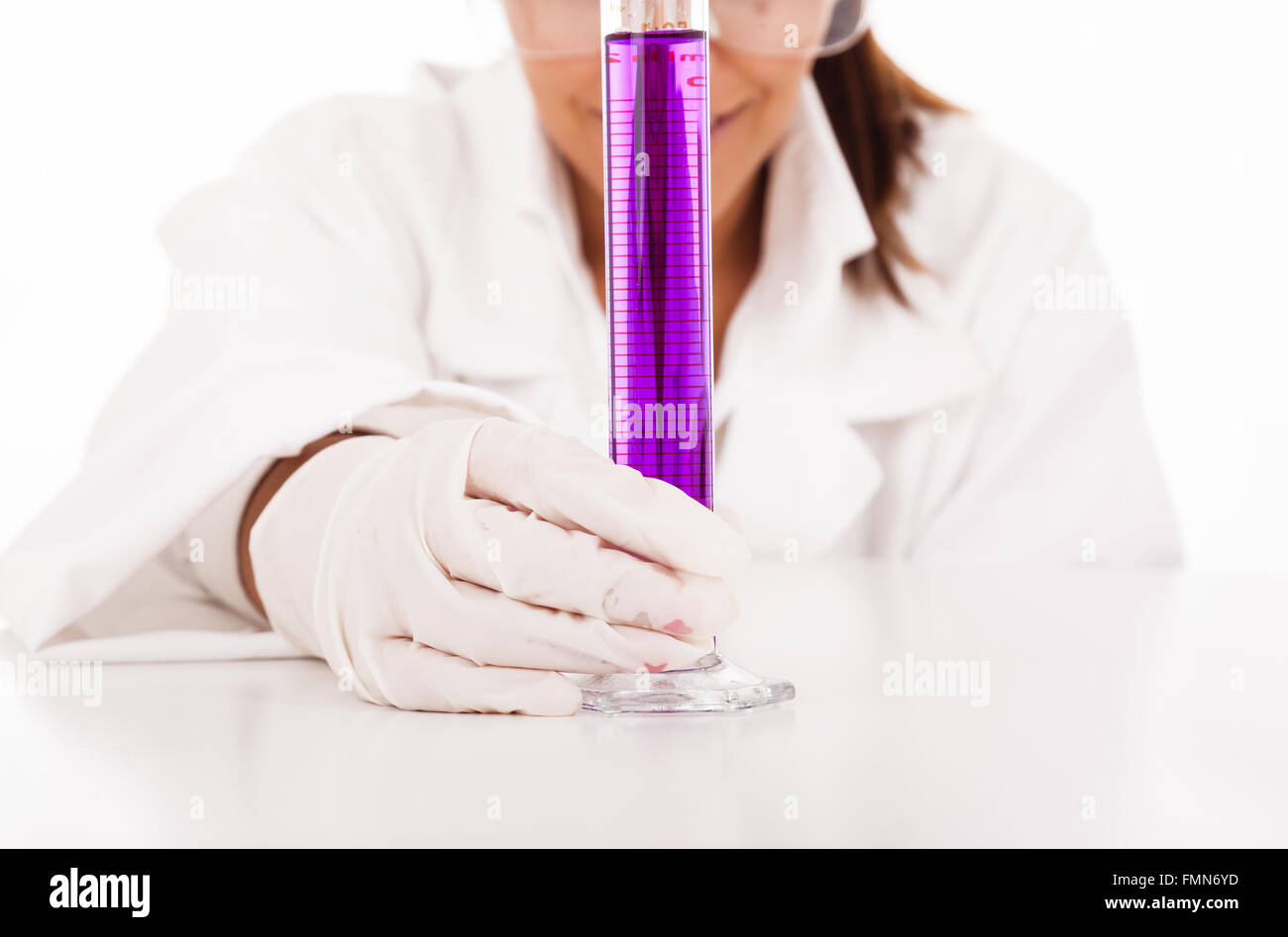 Female researcher checking a flask of liquid, isolated on white Stock ...