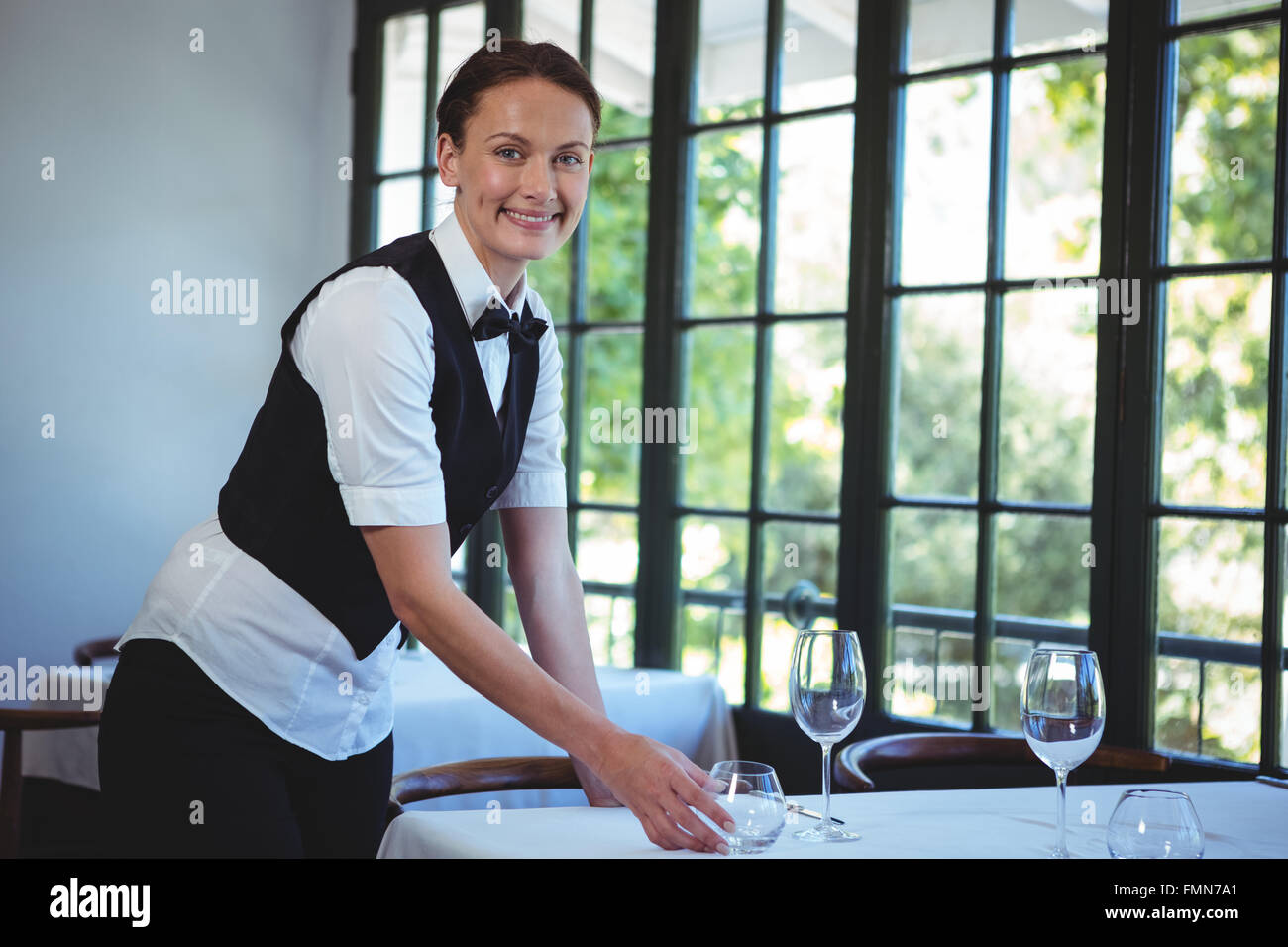Waitress setting the table Stock Photo - Alamy