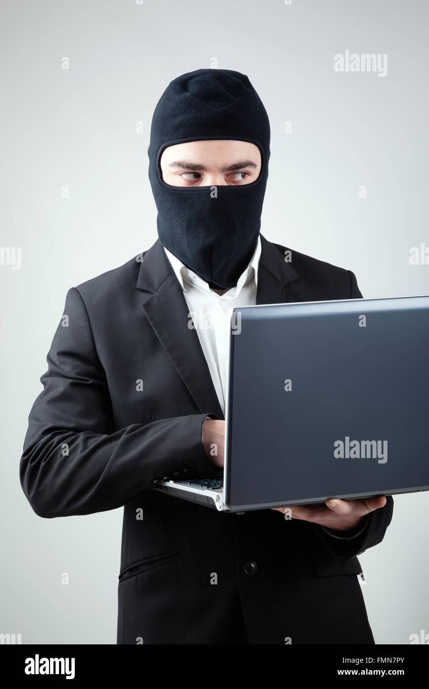 Hacker stealing information from laptop Stock Photo - Alamy
