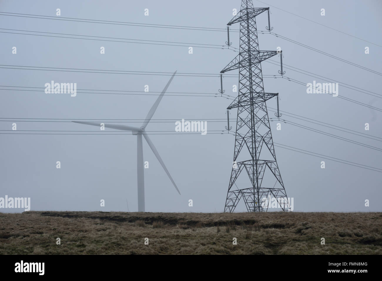 Electricity pylon and high voltage overhead power lines, wind turbine ...