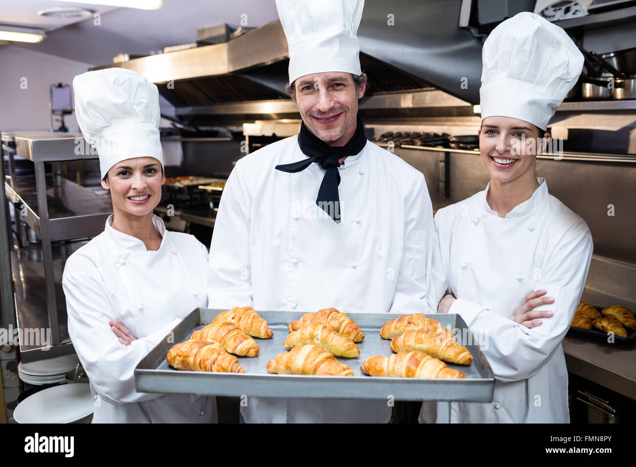 Three chefs holding a tray of baked croissant Stock Photo - Alamy