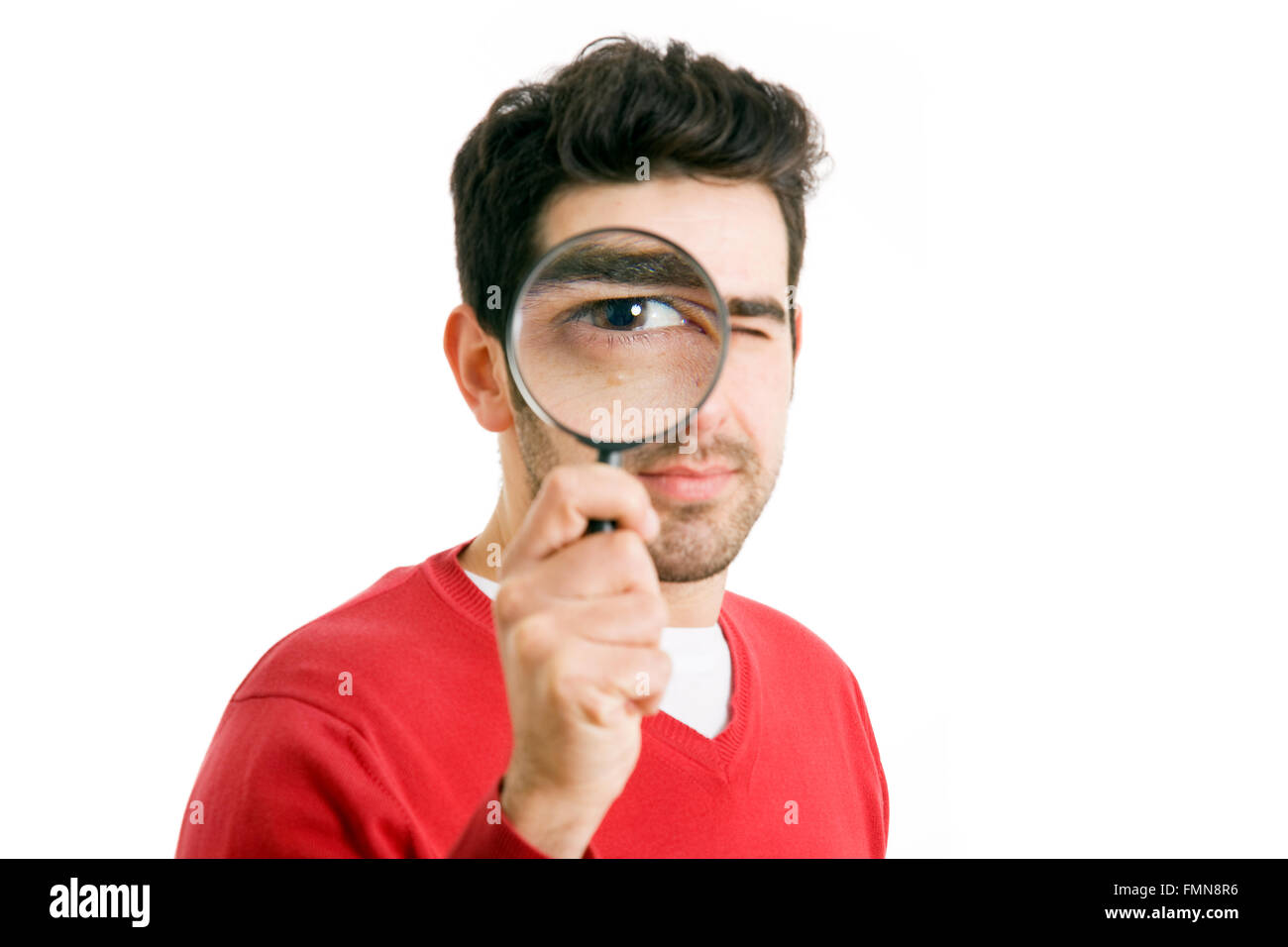 young man looking through magnifying glass, isolated on white Stock ...