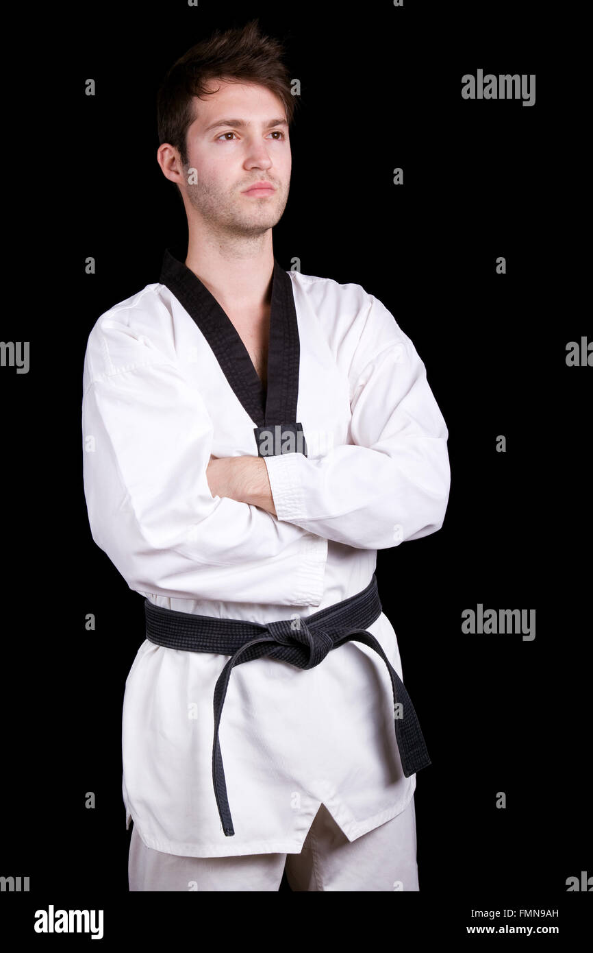 Young martial arts man standing on black background Stock Photo - Alamy