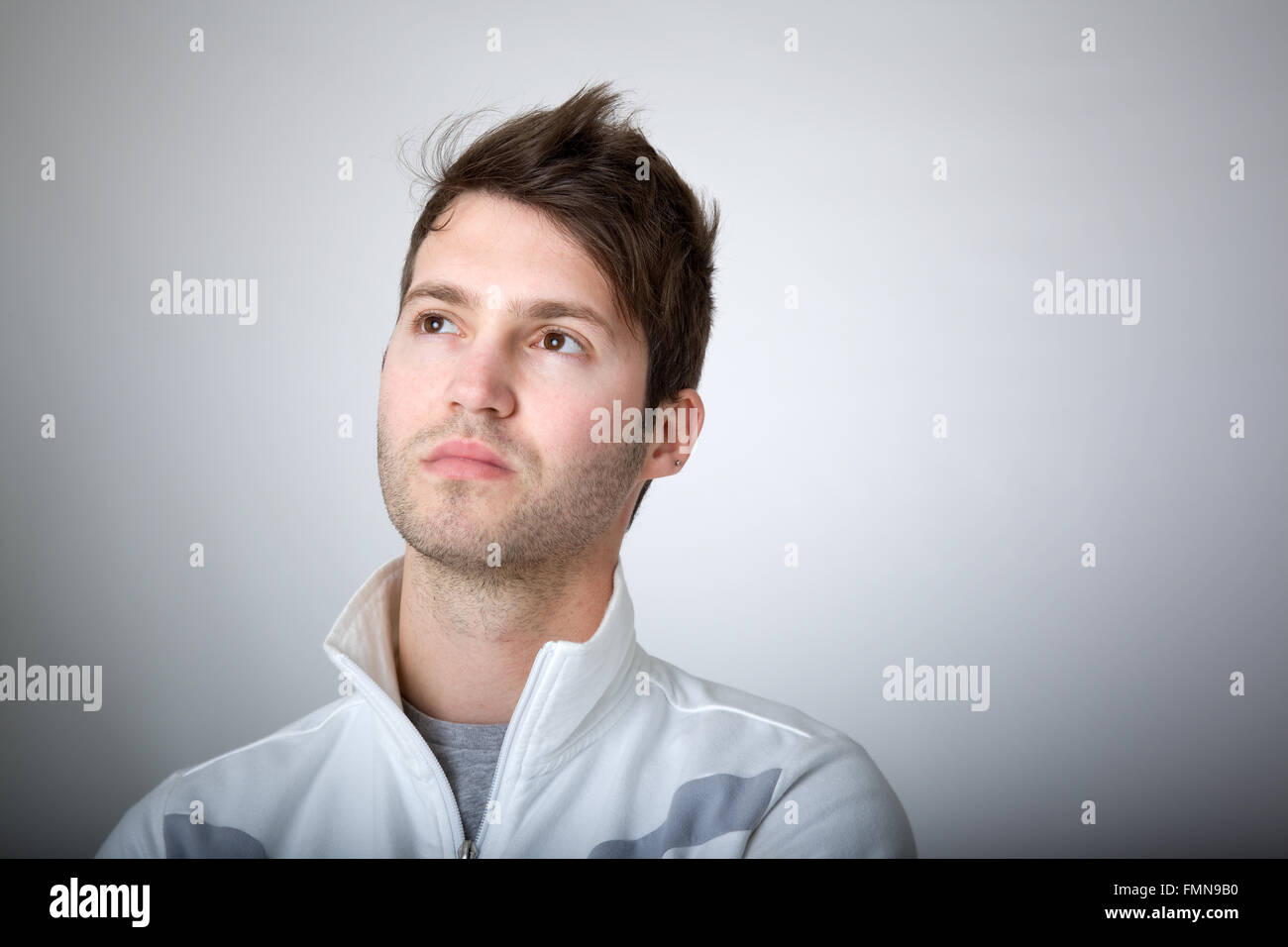Closeup portrait of a casual young pensive man looking up Stock Photo ... Closeup portrait of a casual young pensive man looking up Stock Photo ...