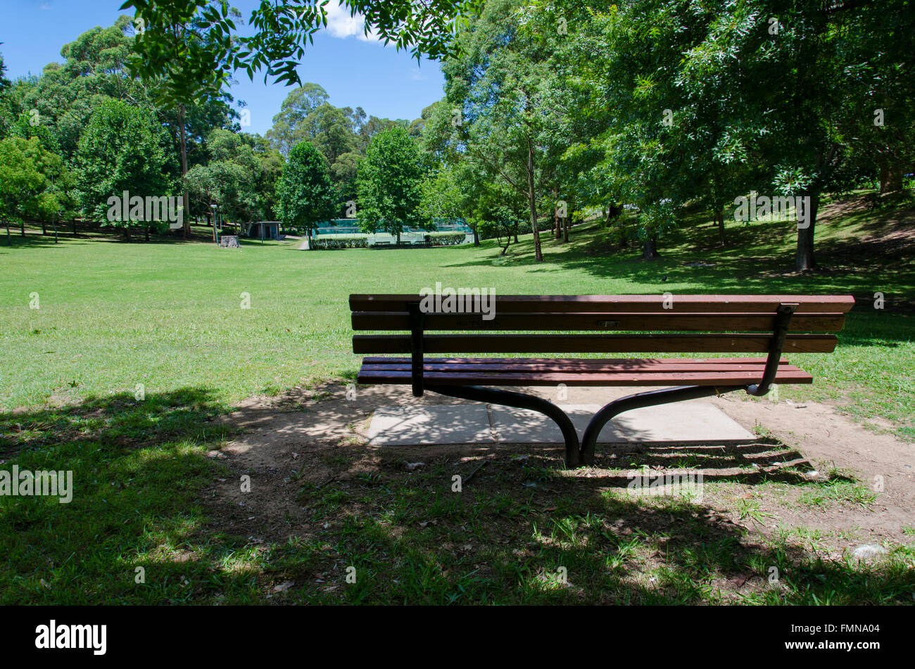 An unoccupied park bench in a sunny Sydney park Stock Photo - Alamy