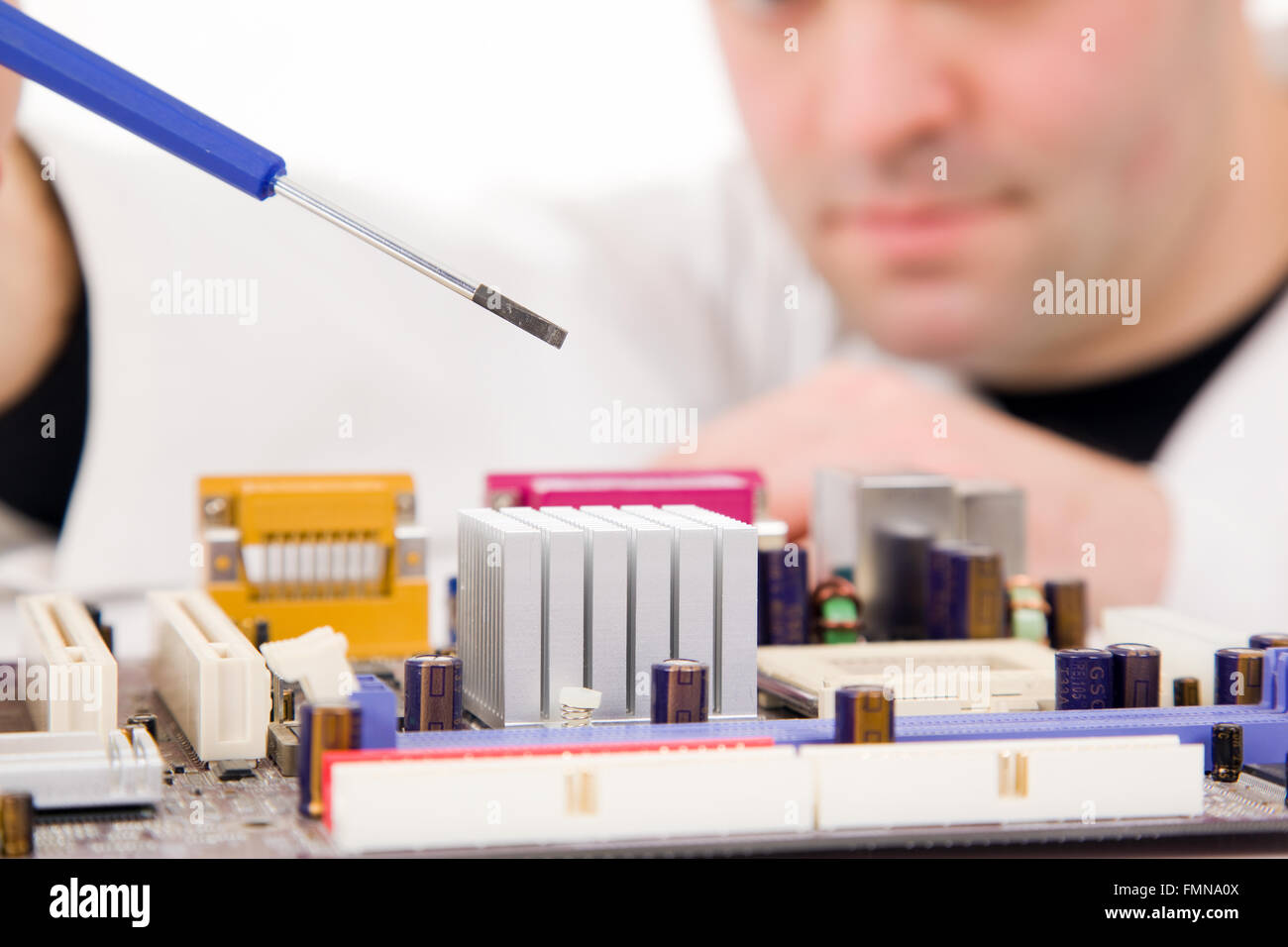 Computer Engineer examining/repairing a electronic circuit, isolated ...
