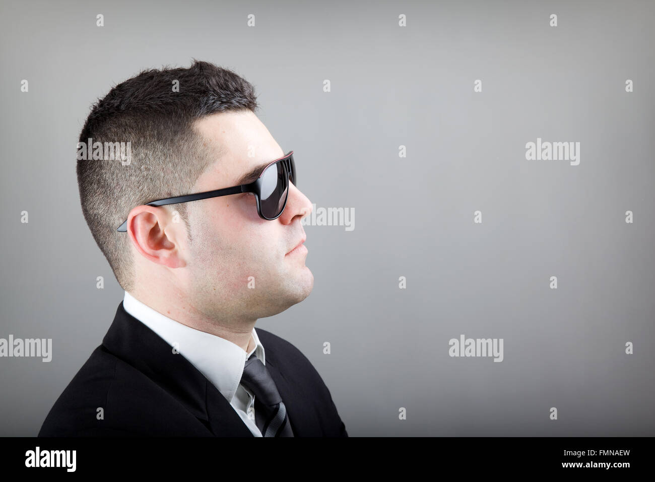 Young business man profile on gray background Stock Photo - Alamy