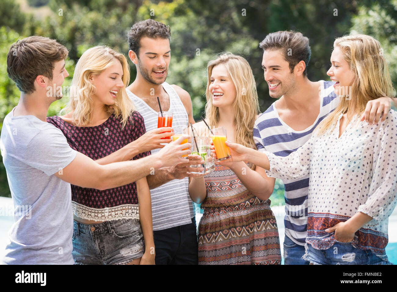Group of friends toasting their juice glasses Stock Photo - Alamy